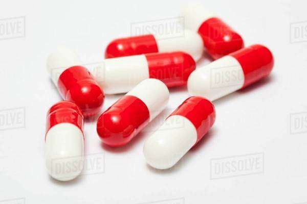 Red and white capsules - Royalty-free Stock Photo | Dissolve