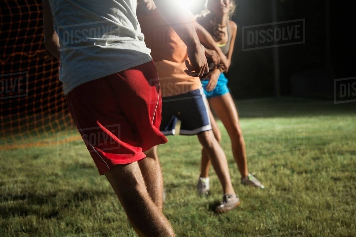 Friends playing soccer at night - Royalty-free Stock Photo | Dissolve