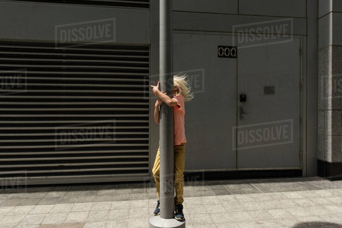 Boy hugging lamp post on day trip in Toronto, Canada - Royalty-free ...
