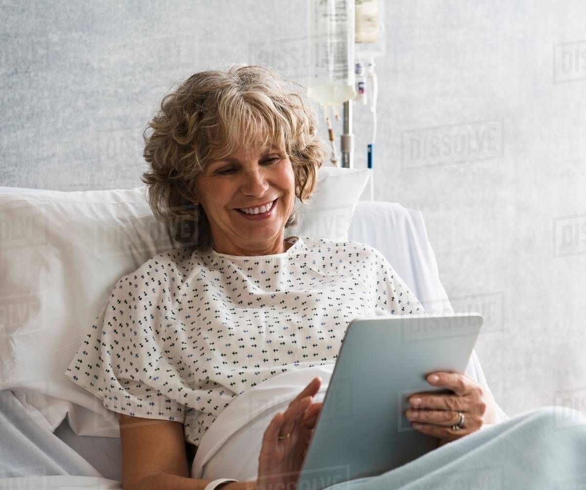 Female hospital patient using digital tablet - Royalty-free Stock Photo ...