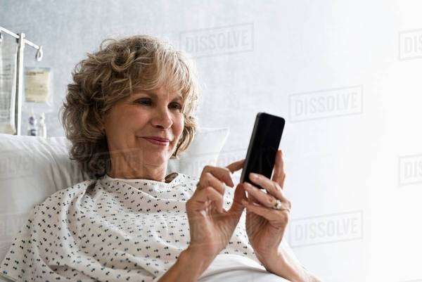 Female hospital patient using cellphone - Royalty-free Stock Photo ...