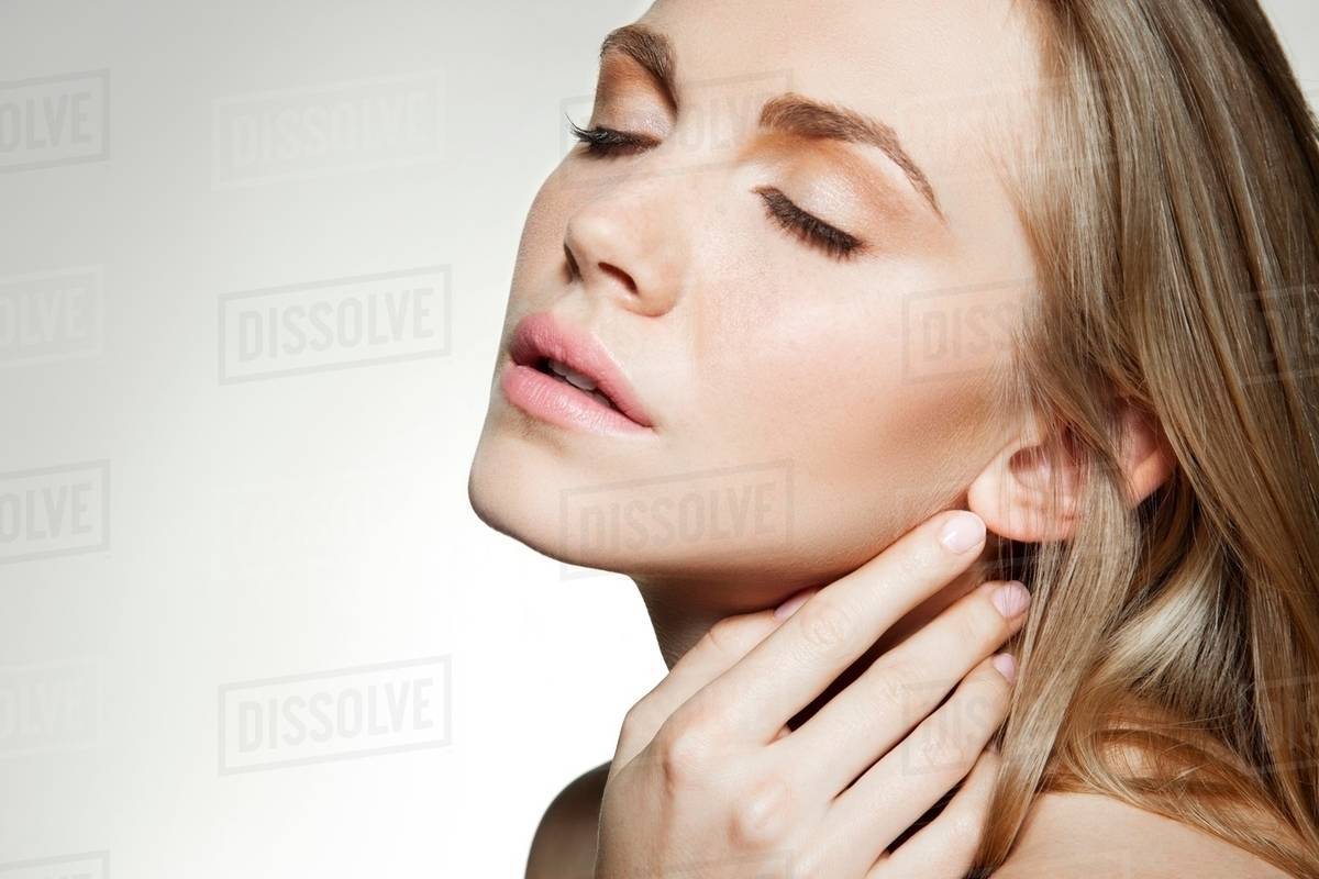 Woman touching skin - Stock Photo - Dissolve
