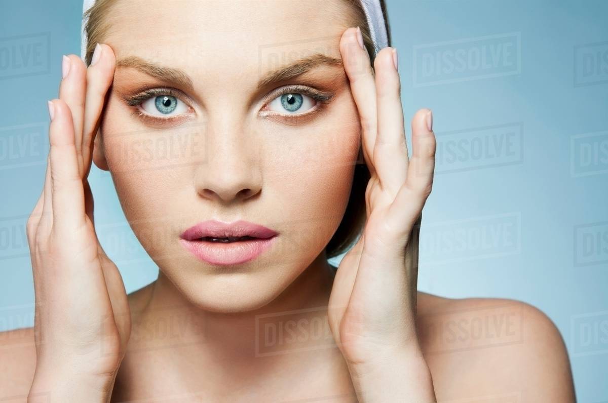 Woman touching face - Stock Photo - Dissolve