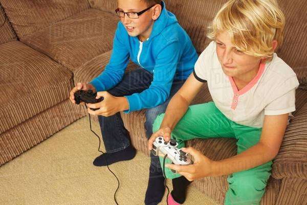 Two boys playing video game - Royalty-free Stock Photo | Dissolve