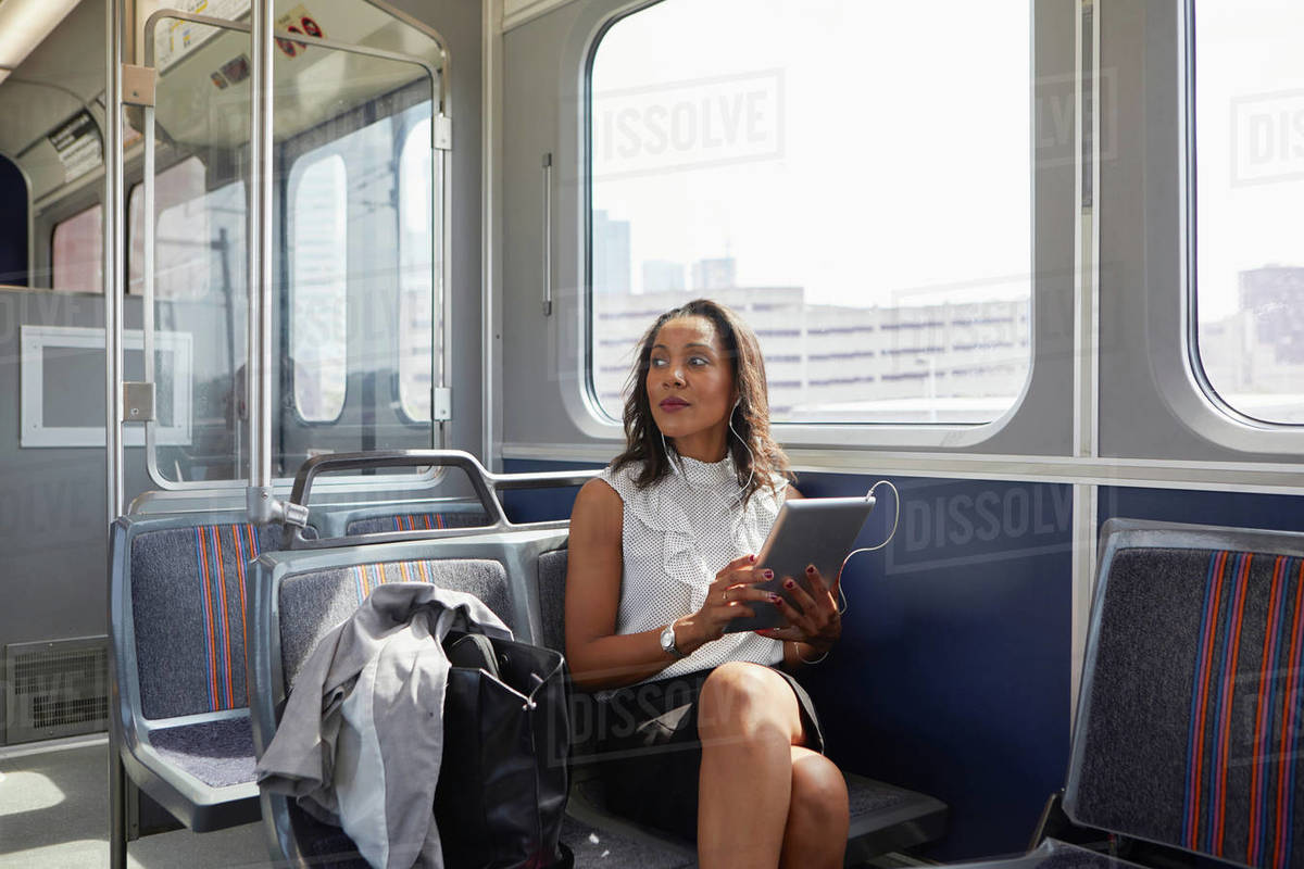 Businesswoman using digital tablet on train - Royalty-free Stock Photo ...