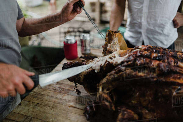 Man slicing hog roast on table, cropped - Royalty-free Stock Photo ...