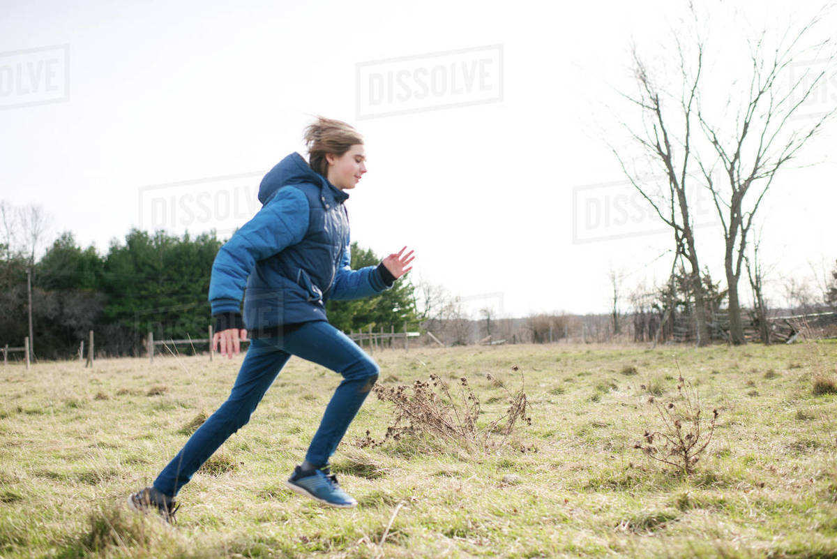 Boy running in field - Royalty-free Stock Photo | Dissolve