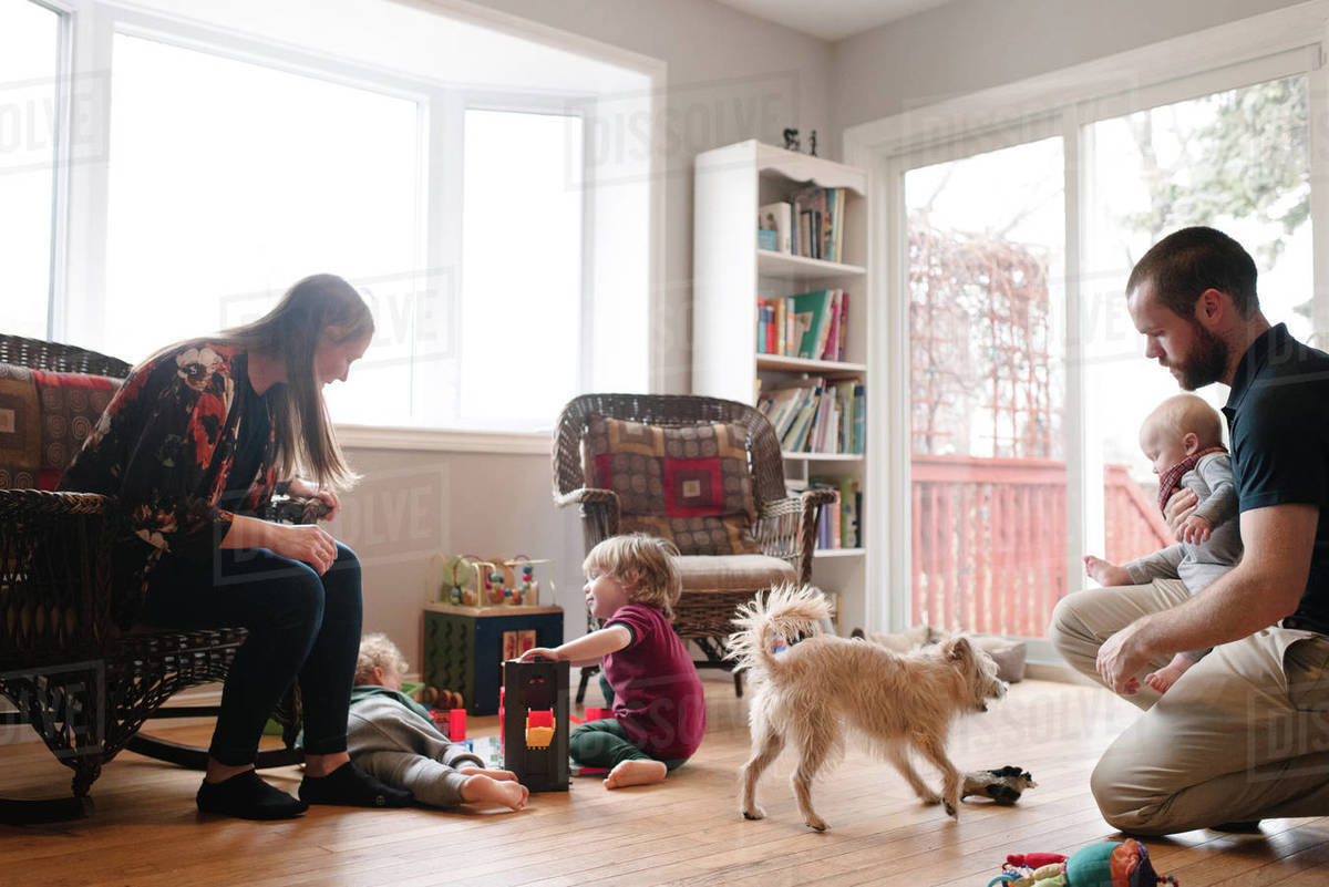 Family and sons with pet dog in living room - Royalty-free Stock Photo ...