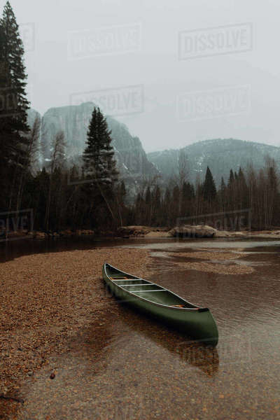 Canoe beached on river shallows, Yosemite Village, California, USA ...