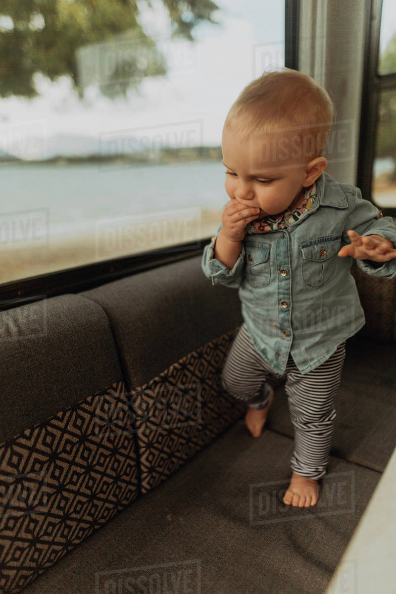 Baby walking on sofa in motorhome, Wanaka, Taranaki, New Zealand ...