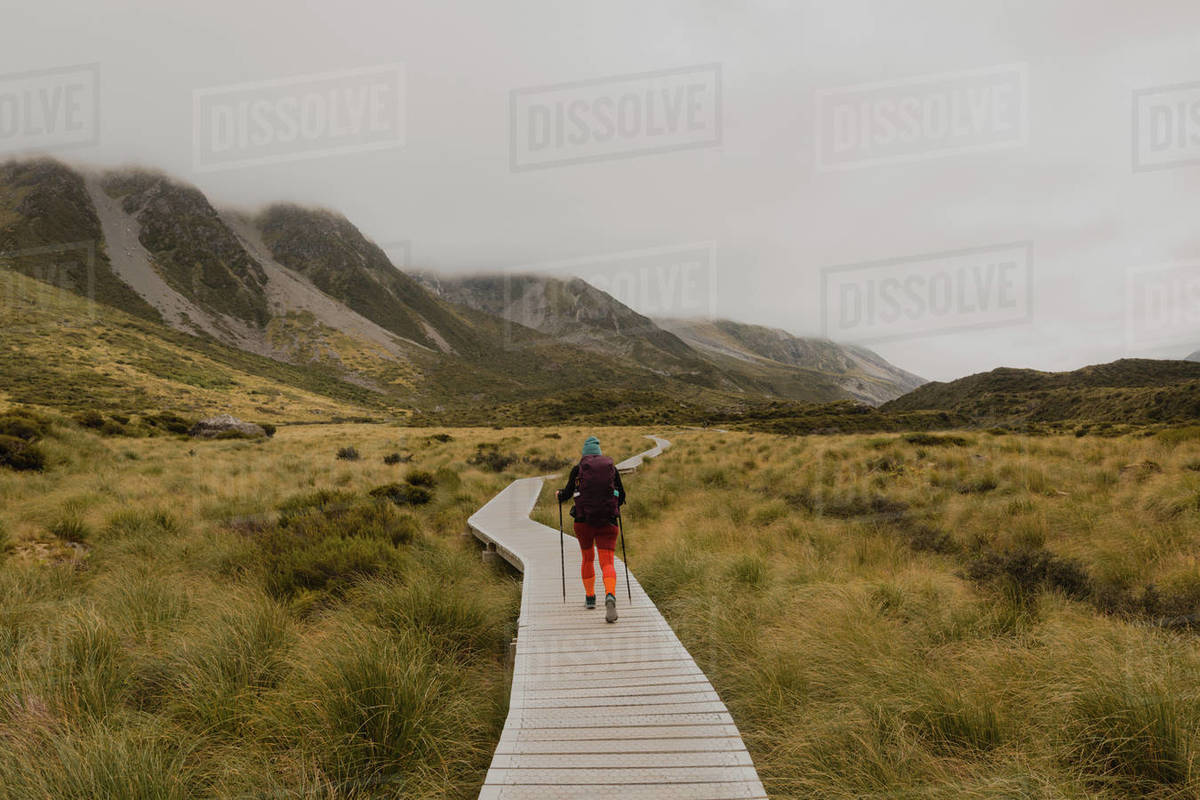 Hiker walking on trail path, Wanaka, Taranaki, New Zealand - Royalty ...
