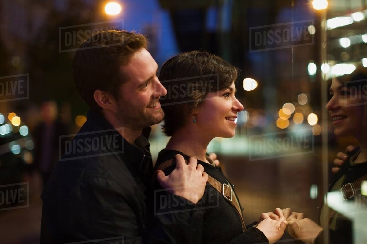 Couple window shopping on city street - Stock Photo - Dissolve