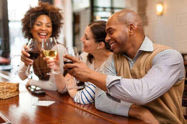 Three people toasting - Royalty-free Stock Photo | Dissolve