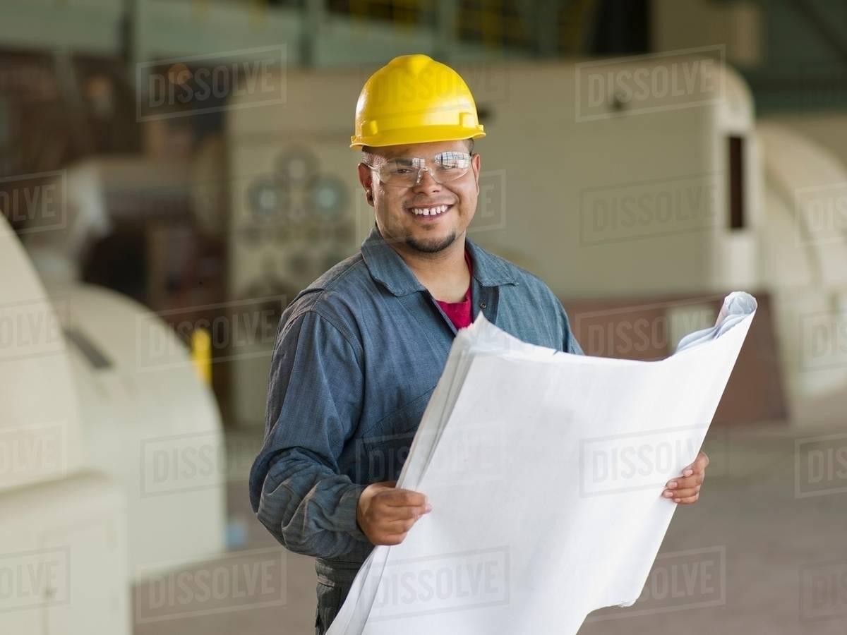 Engineer reading blueprints on site - Royalty-free Stock Photo | Dissolve