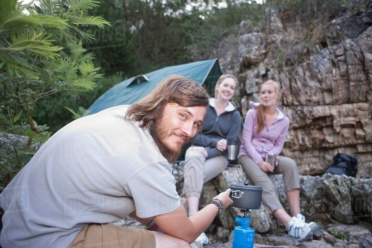 Group of young people camping - Stock Photo - Dissolve