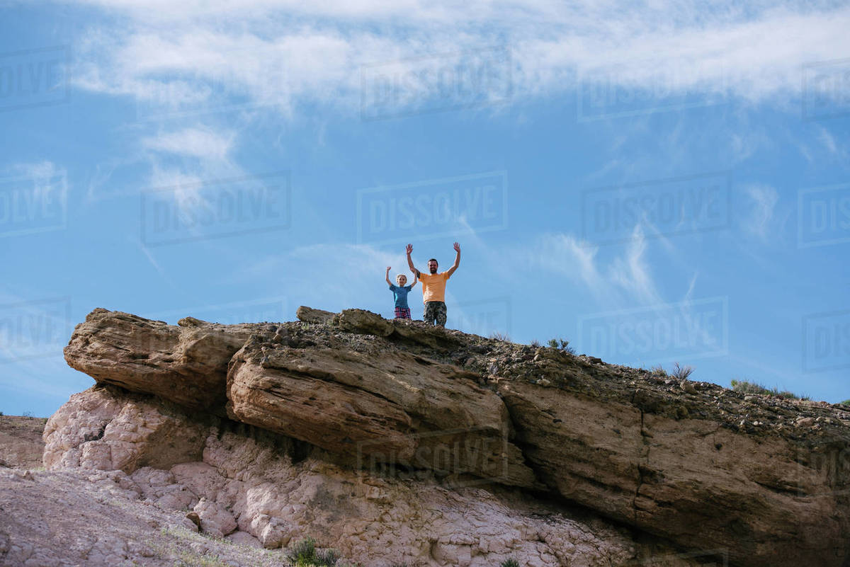 Father and son rejoicing on peak, Red Rock Canyon, Cantil, California ...