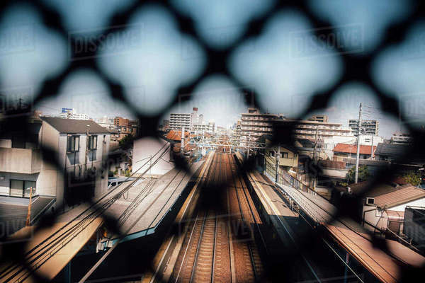 Train tracks seen through fencing, Tokushima-shi, Tokushima, Japan ...