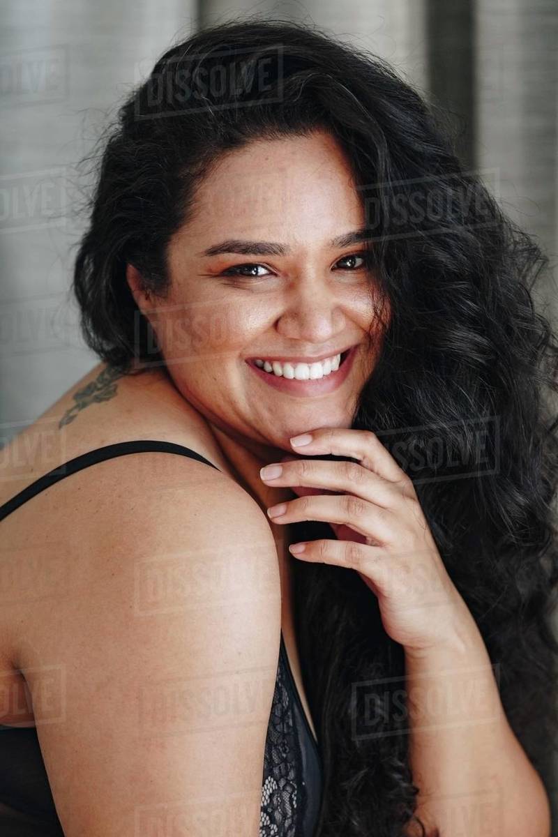 Woman in lingerie smiling coyly - Royalty-free Stock Photo | Dissolve