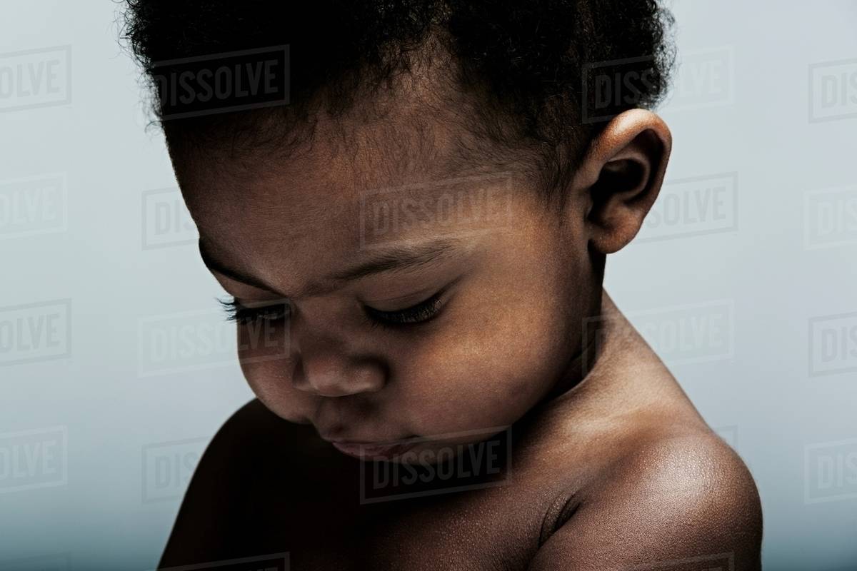 Portrait of baby boy looking down - Royalty-free Stock Photo | Dissolve