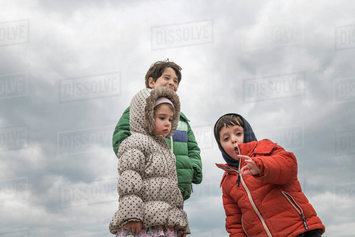 Siblings exploring beach - Royalty-free Stock Photo | Dissolve