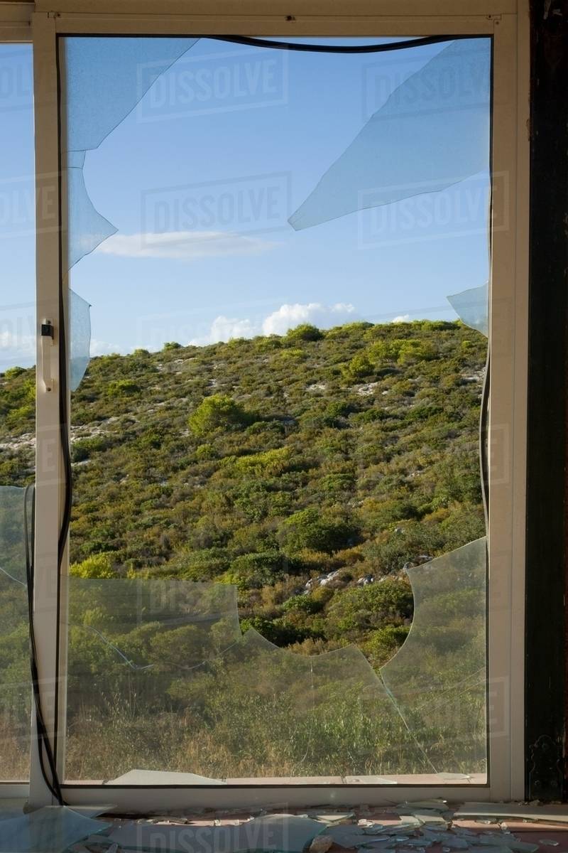 View through broken window - Stock Photo - Dissolve