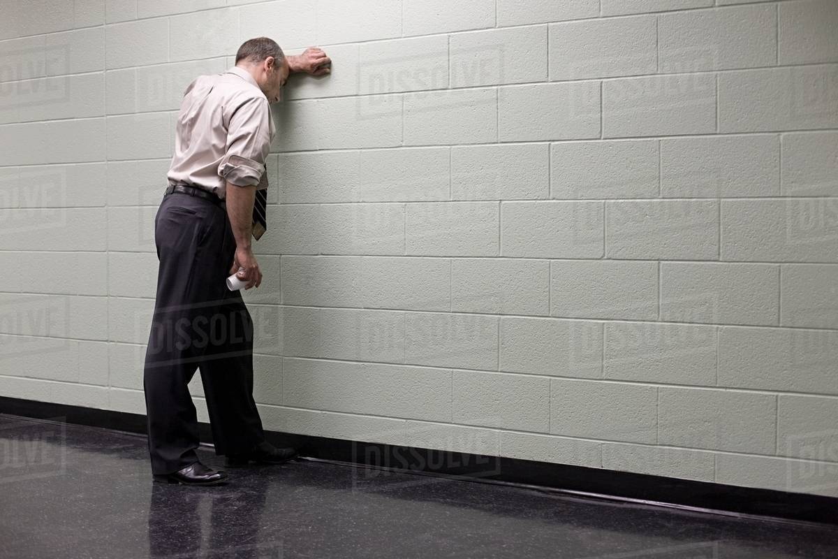 Man leaning against wall - Royalty-free Stock Photo | Dissolve