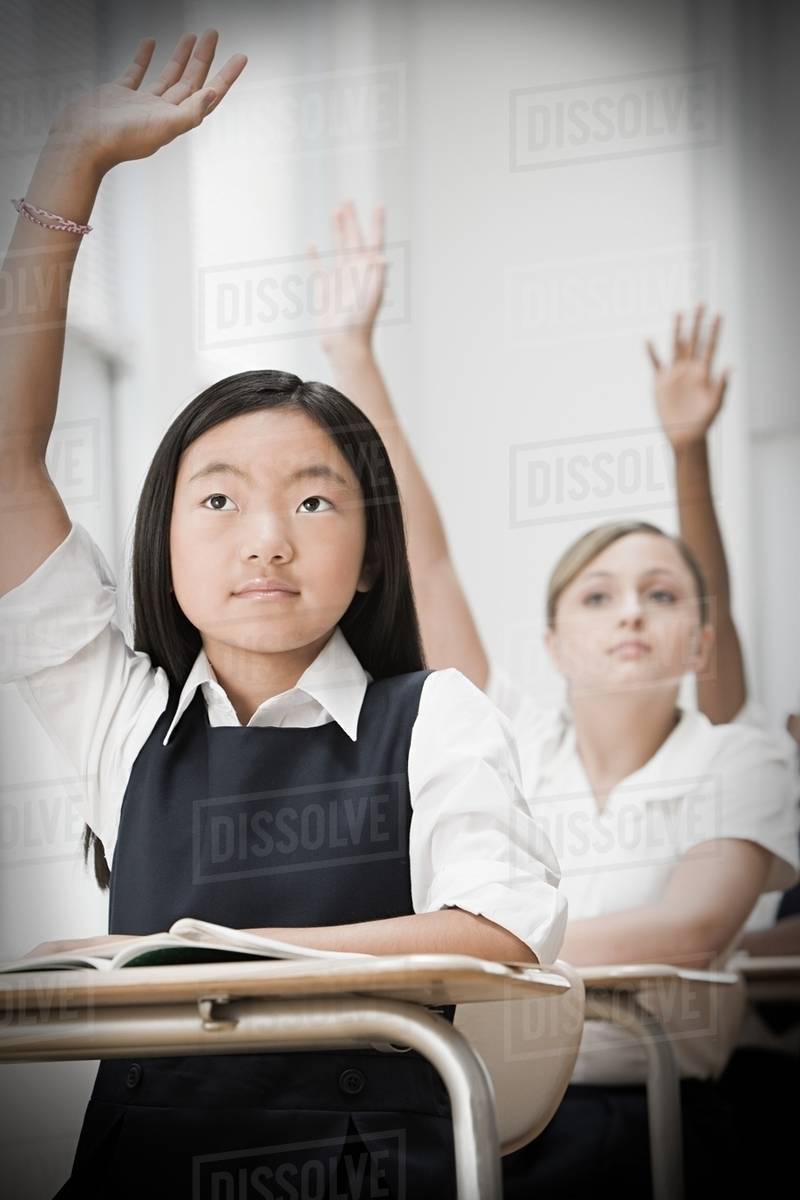 School students with hands raised - Royalty-free Stock Photo | Dissolve