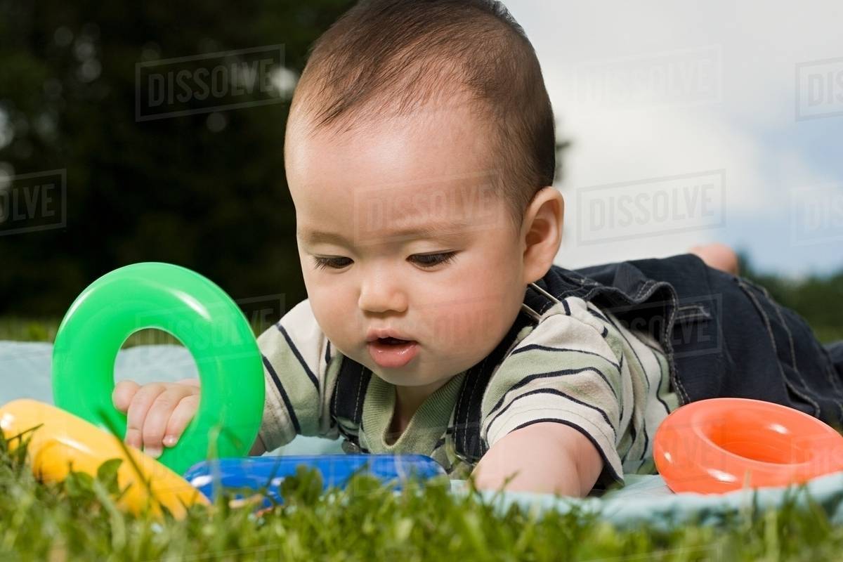 Baby playing with plastic rings - Royalty-free Stock Photo | Dissolve