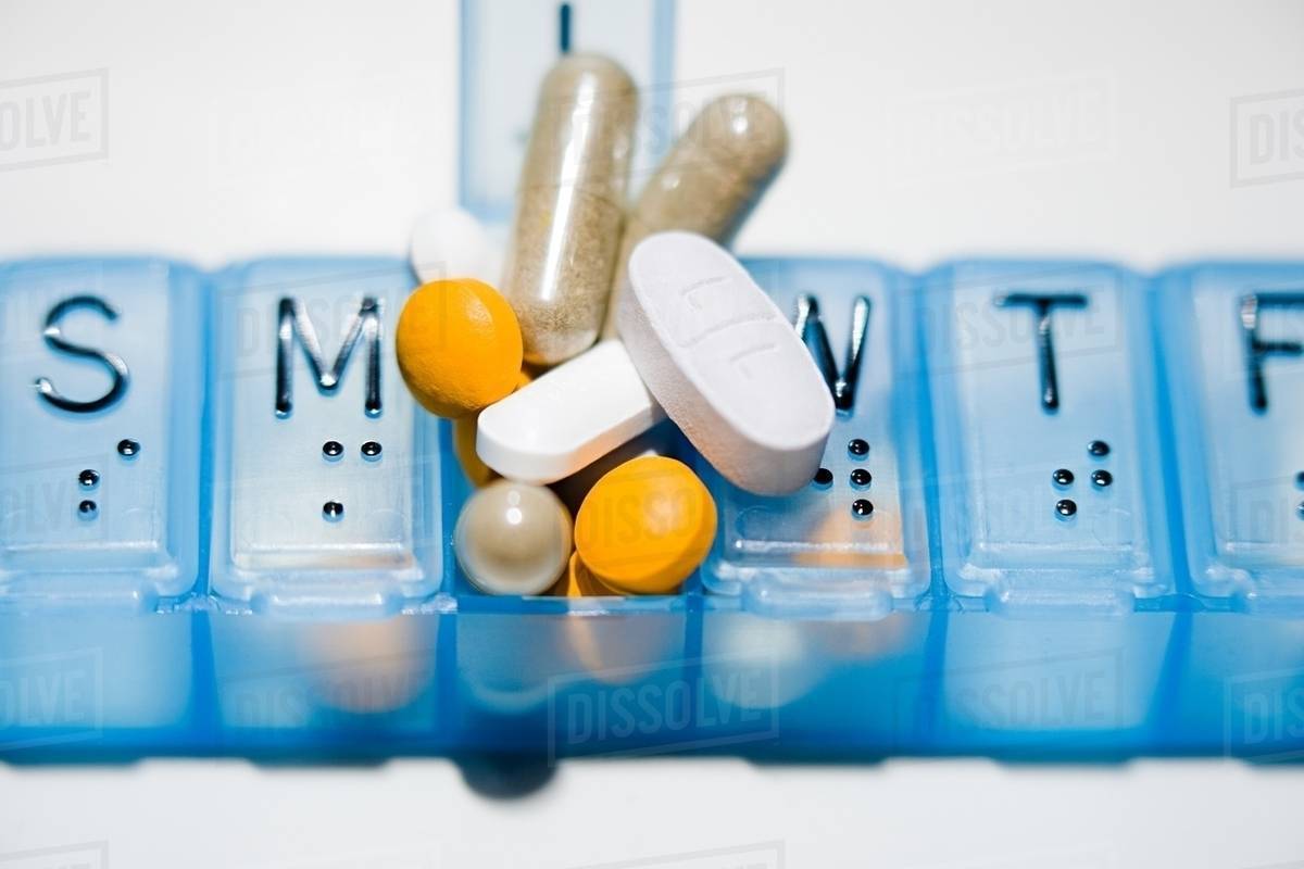 Pillbox with lots of tablets - Royalty-free Stock Photo | Dissolve