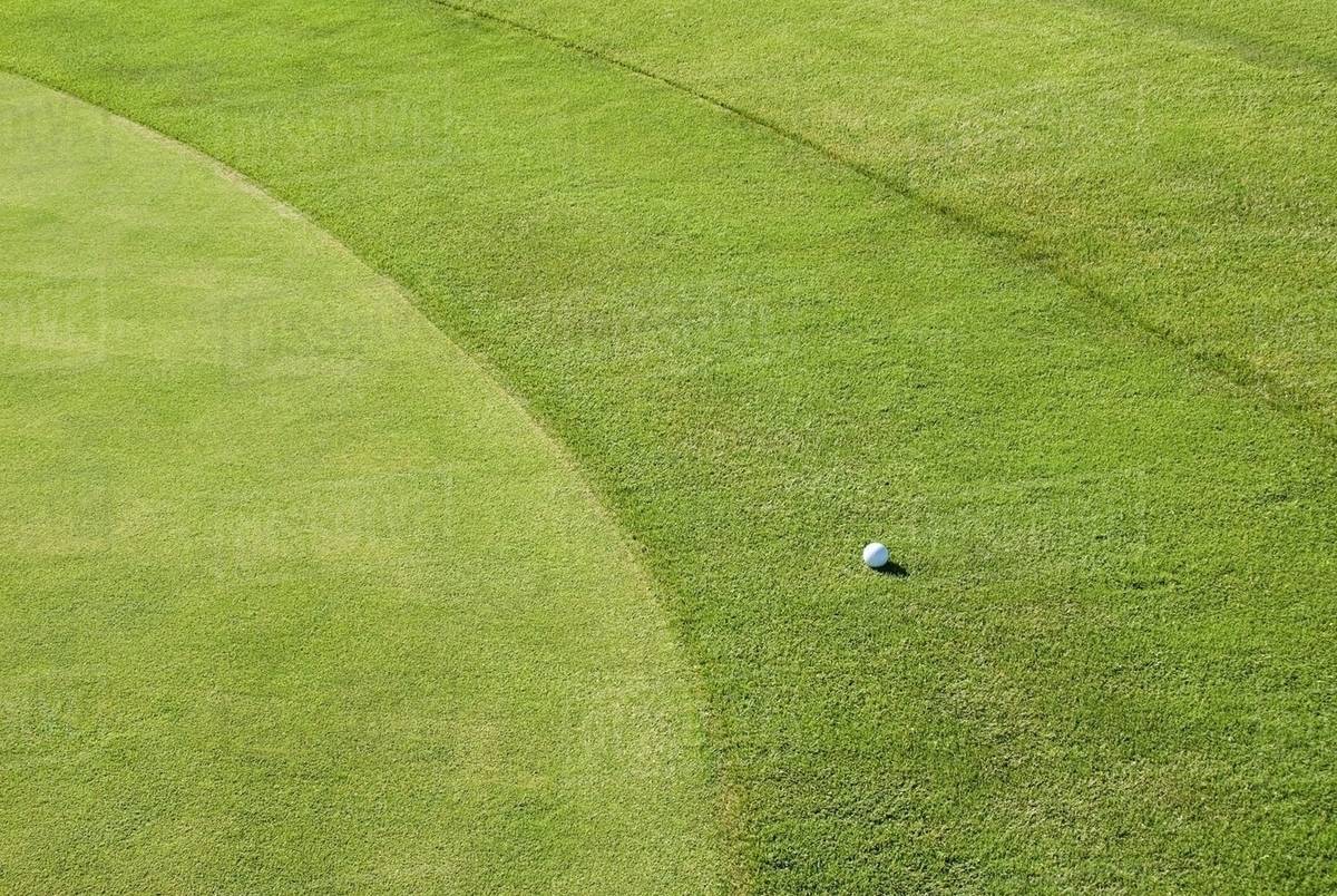 Golf ball on golf course - Stock Photo - Dissolve