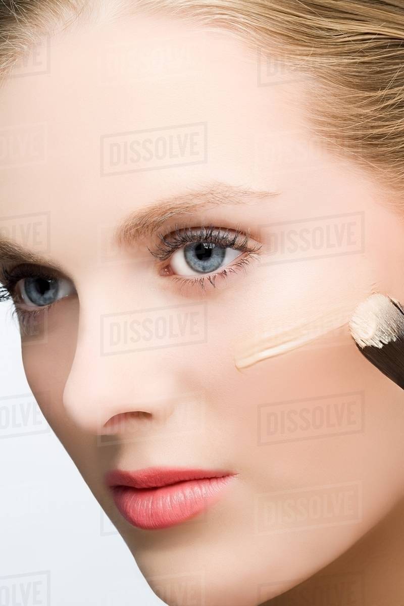 Woman applying foundation - Stock Photo - Dissolve
