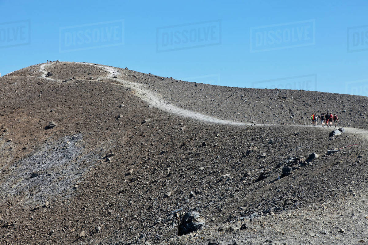 Hikers walking up rocky slope - Royalty-free Stock Photo | Dissolve