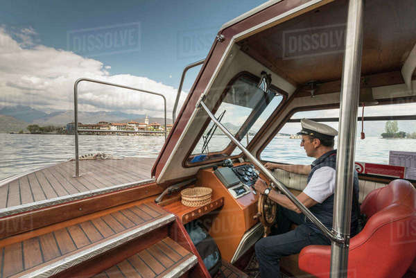 Captain driving tour boat, Lago Maggiore, Isole Borromee, Isola dei ...