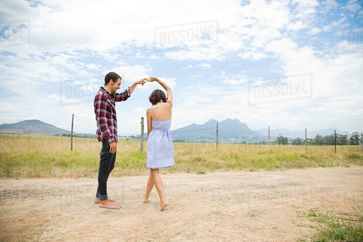 Couple dancing in a field - Stock Photo - Dissolve