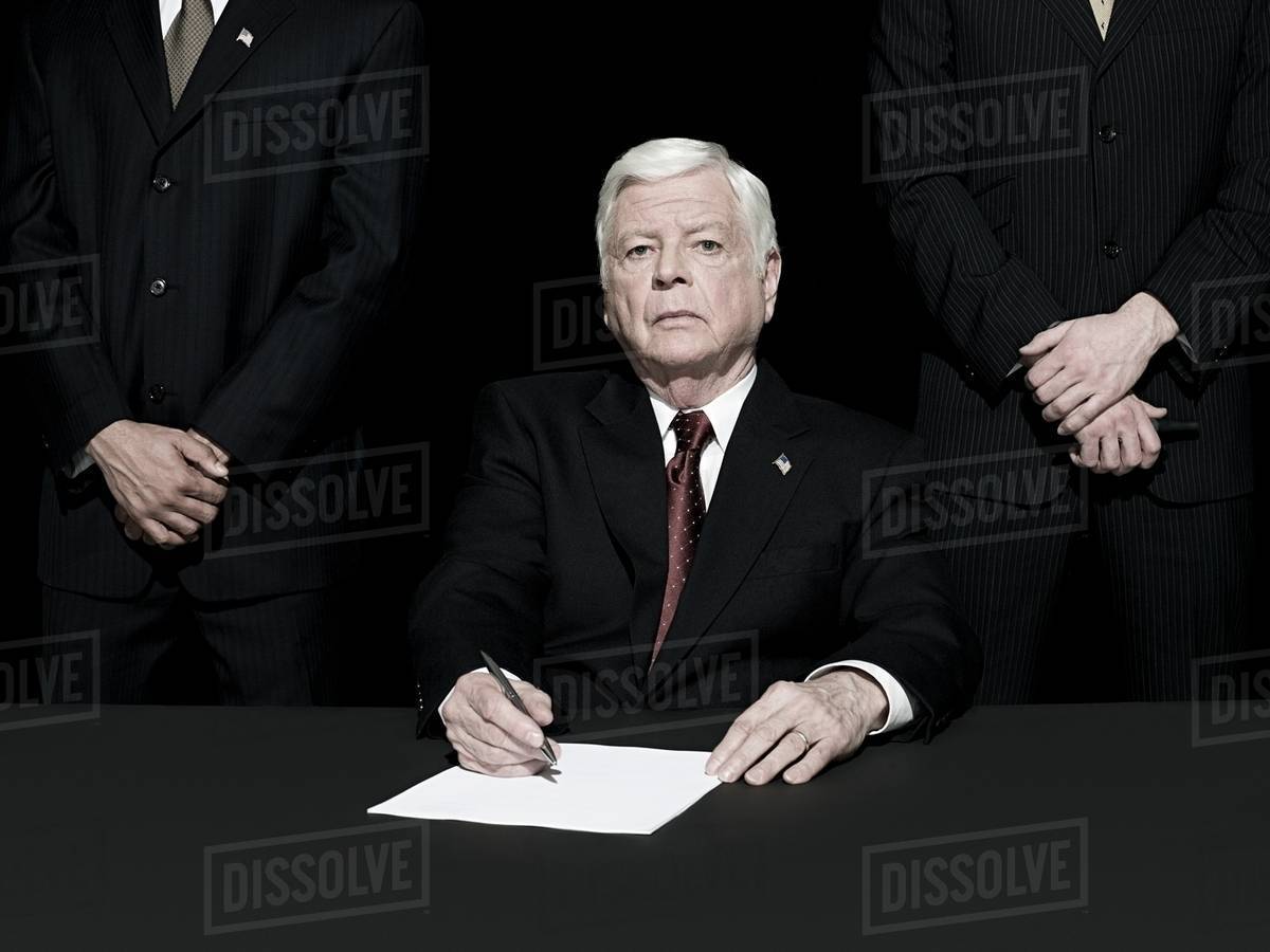 Politician signing paper - Royalty-free Stock Photo | Dissolve