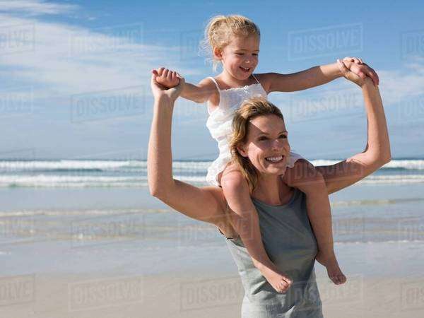 Woman carrying daughter - Stock Photo - Dissolve