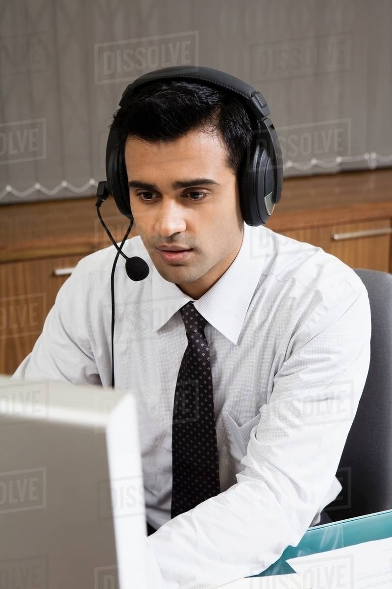 Indian man working in a call centre - Royalty-free Stock Photo | Dissolve