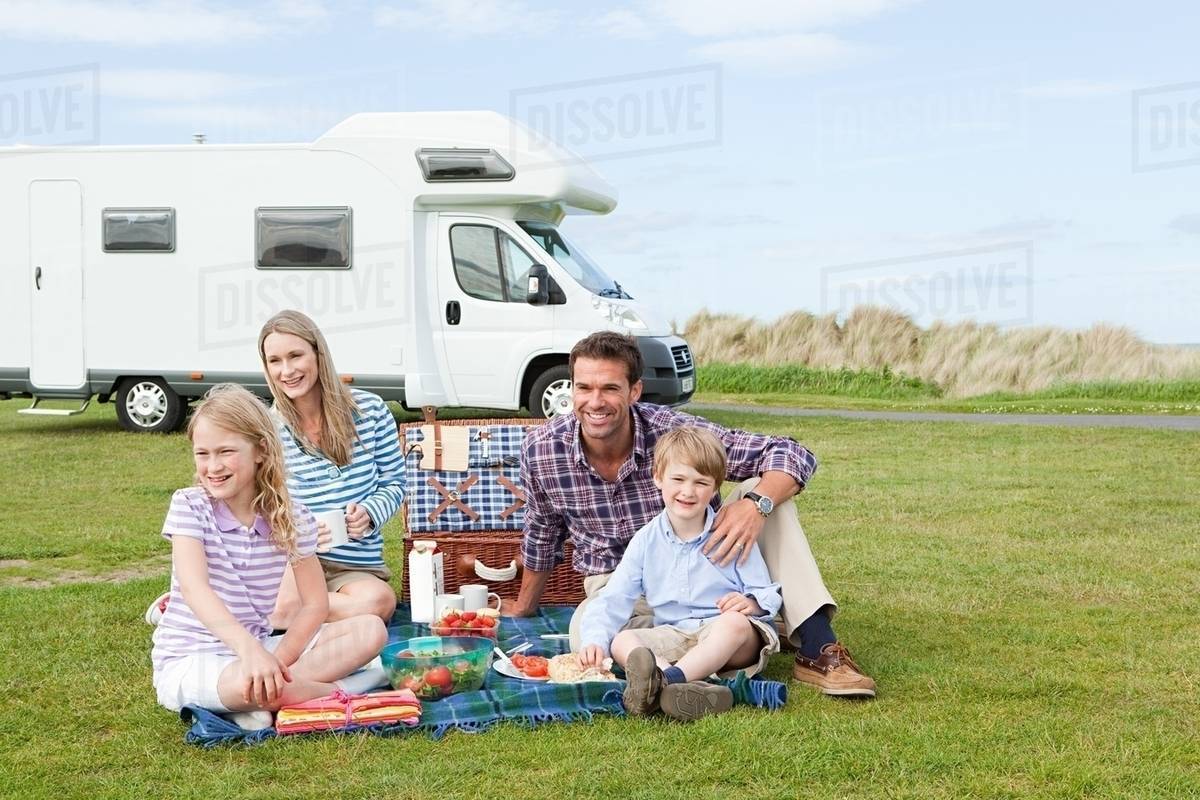 Family having picnic by caravan - Royalty-free Stock Photo | Dissolve