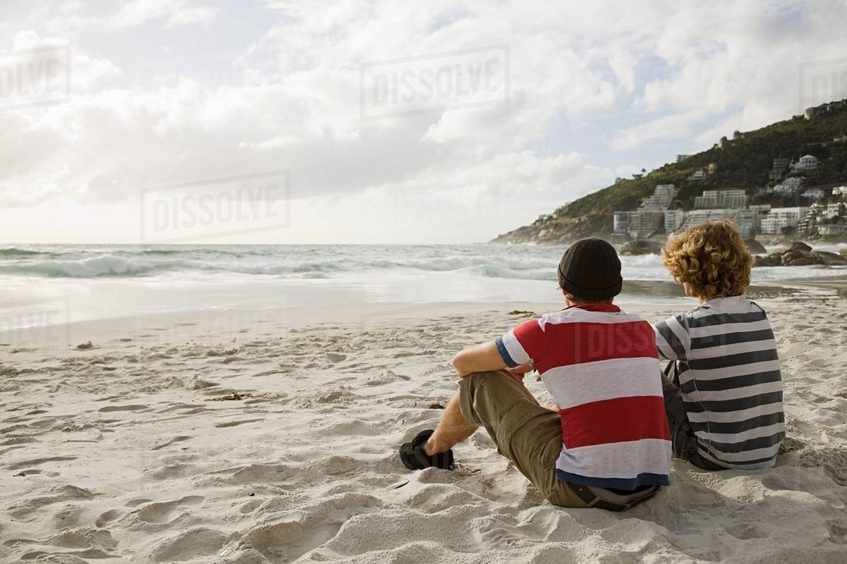 Two boys sitting on beach - Royalty-free Stock Photo | Dissolve