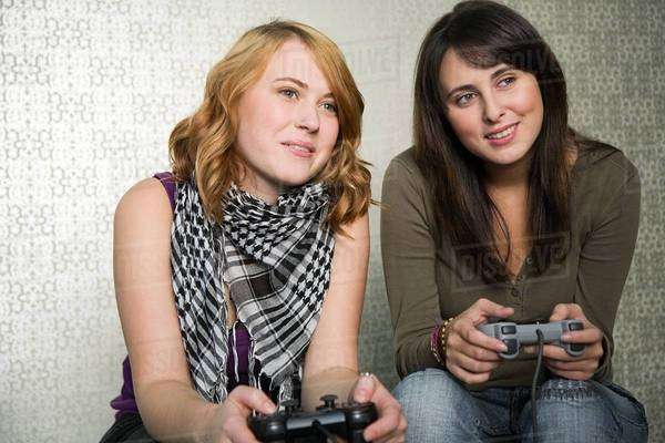 Teenage girls playing on games console - Royalty-free Stock Photo ...