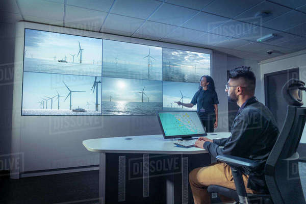 Male and female operators in offshore wind farm control room - Royalty ...