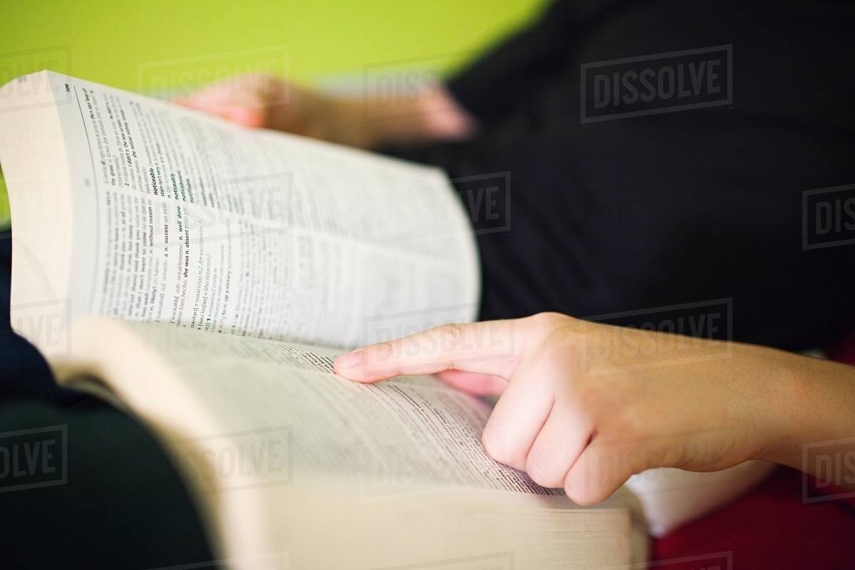 Person reading dictionary - Royalty-free Stock Photo | Dissolve