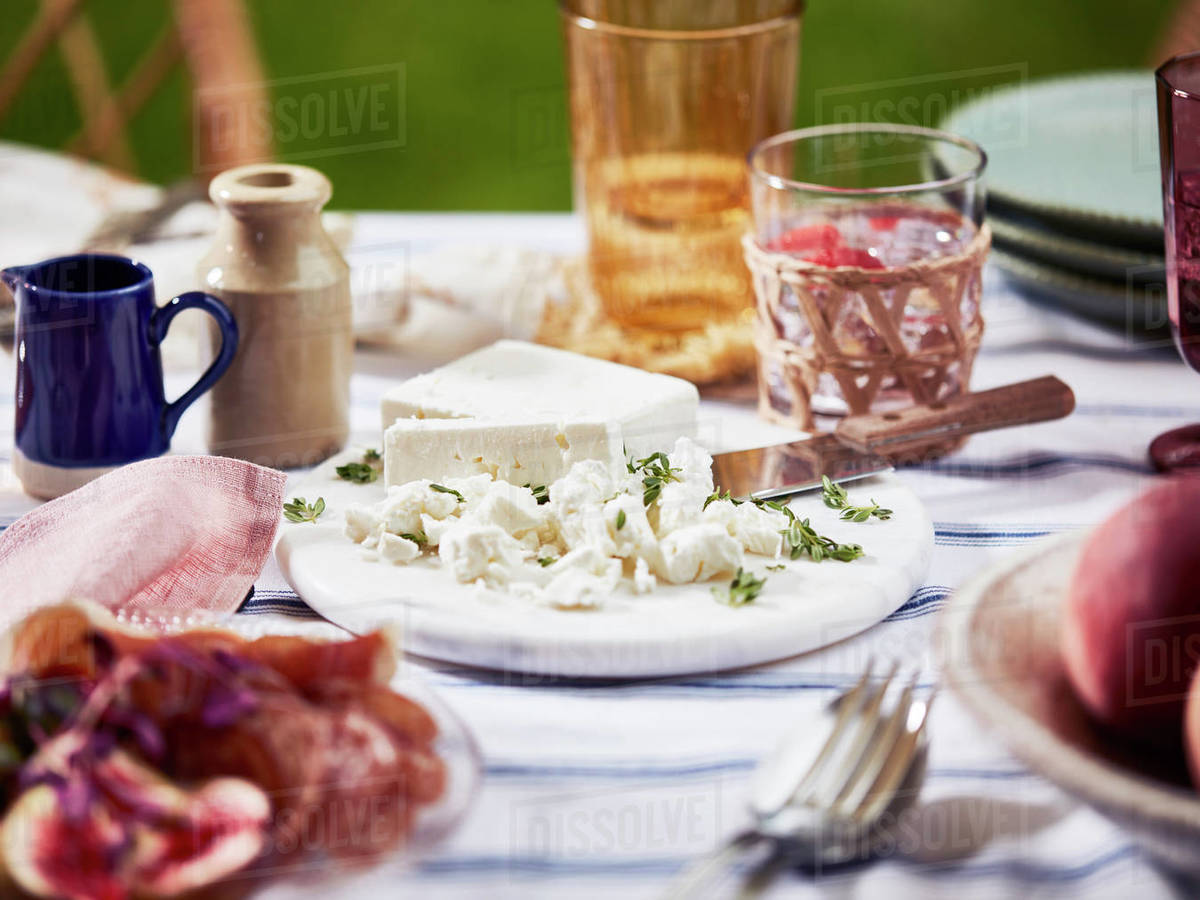 Feta cheese with thyme on plate on table - Royalty-free Stock Photo ...