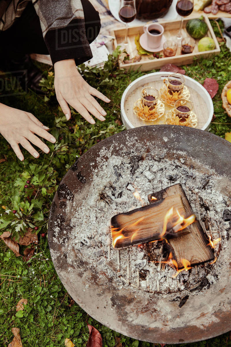 Overhead view of fire pit and tea in glasses with gold holders at ...