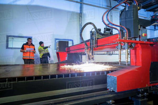Engineers with plasma cutting machine in engineering factory - Royalty ...