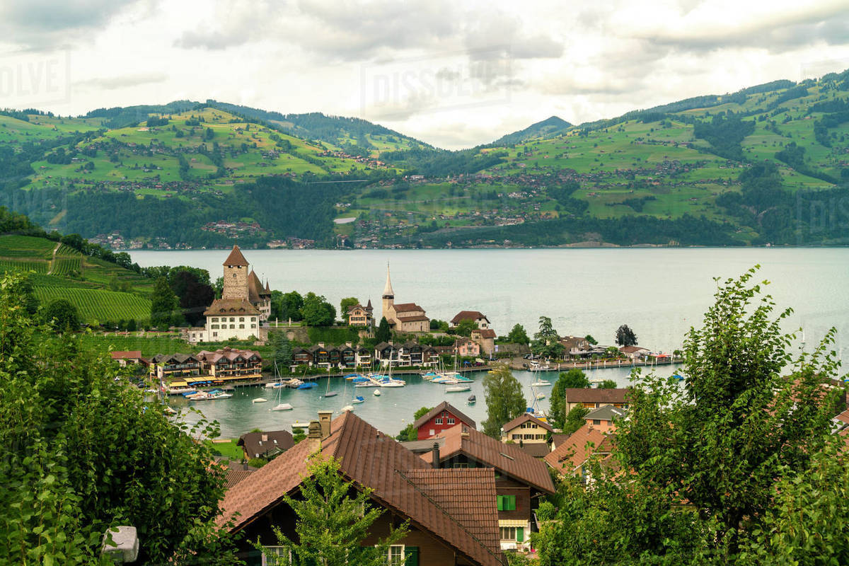 Switzerland, Interlaken, Town and lake in mountain landscape - Royalty ...