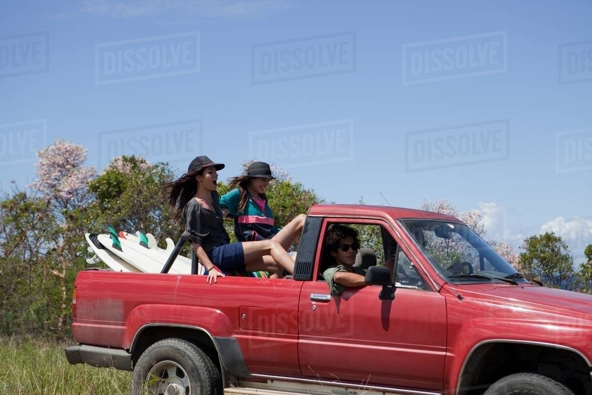 Three young friends driving off road vehicle on vacation - Royalty-free ...