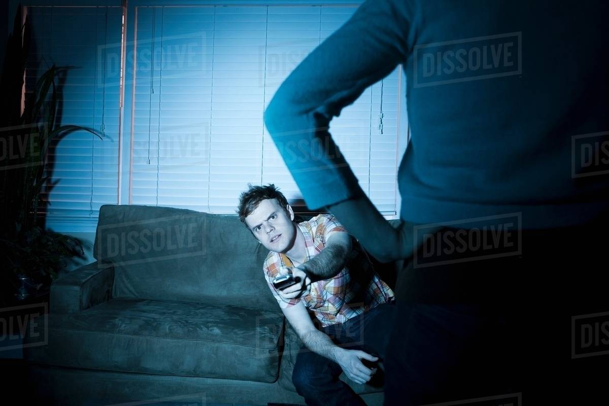 Young man watching tv, woman blocking view - Royalty-free Stock Photo ...