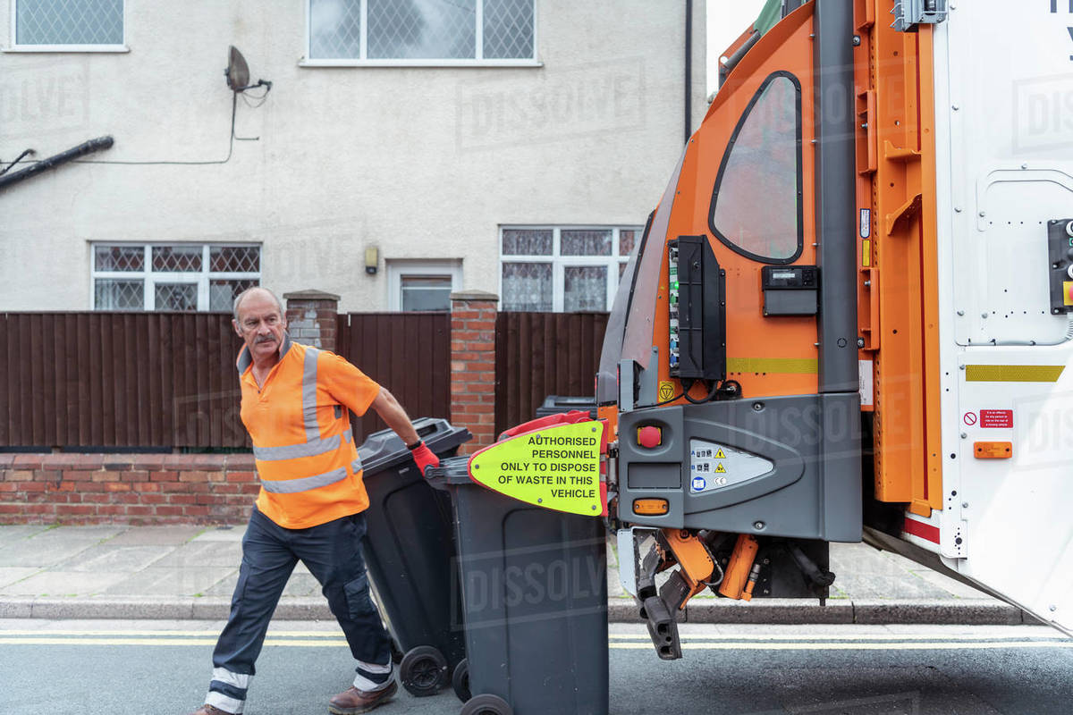 Refuse collector with bins and refuse truck in street - Royalty-free ...