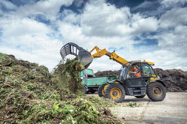 Loader moving compost in waste to energy power station - Royalty-free ...